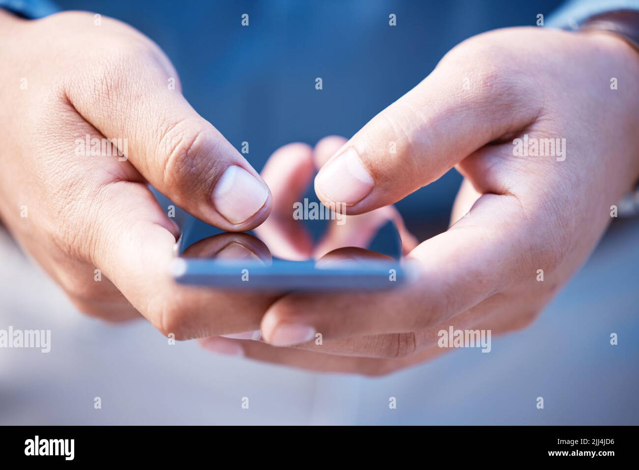 Fast as lightning. a businessman using a smartphone to send a text ...