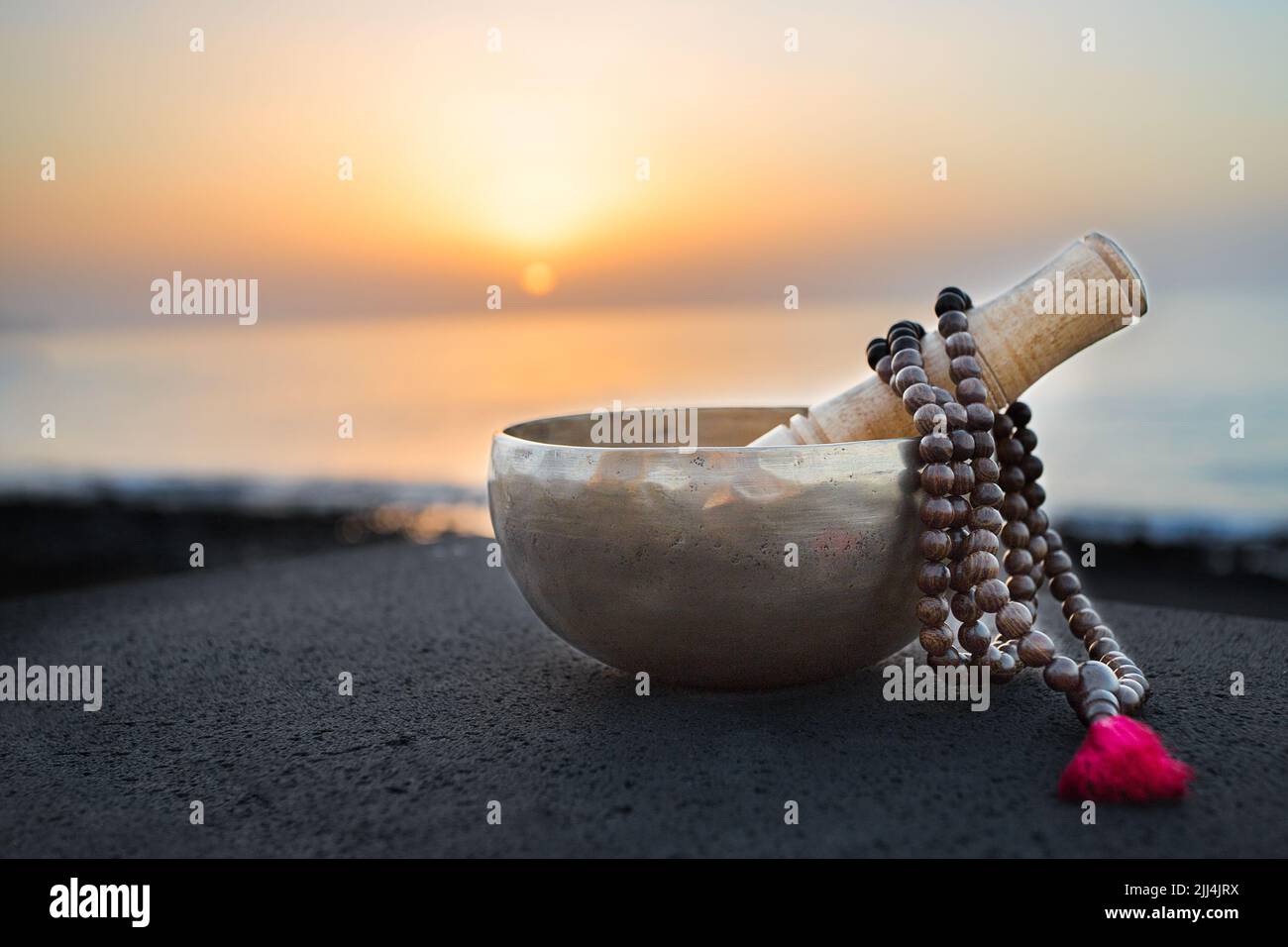 Tibetan bowl with mala beads on nature seaside background for ...