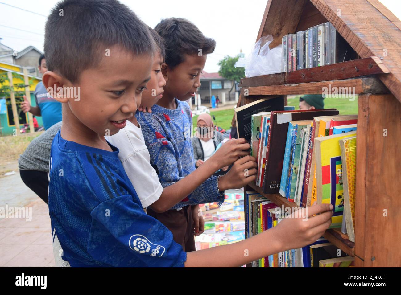 Indonesia, 2021 : children reading a book in a public space park at ...
