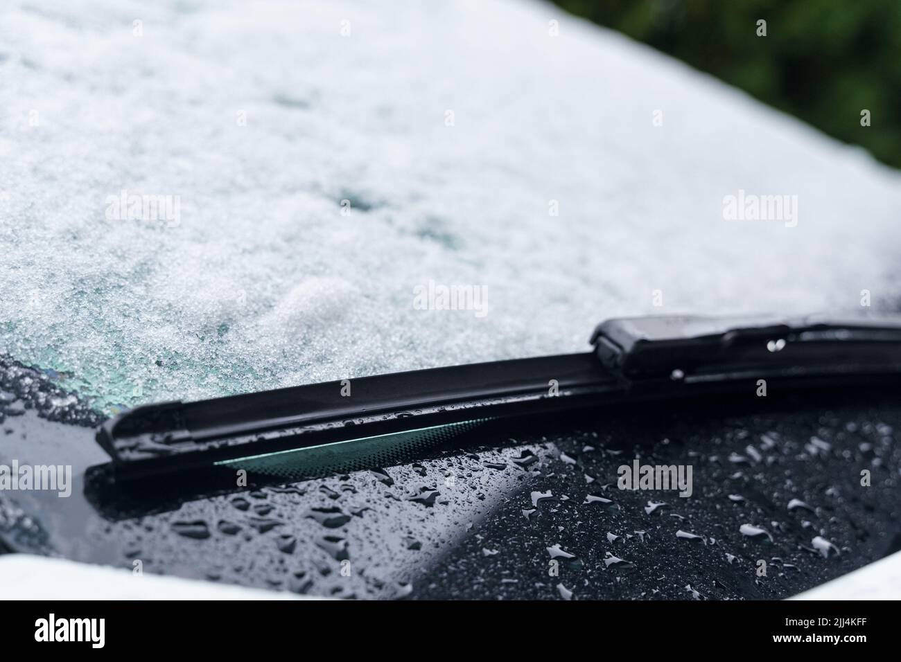 Weather and transport concept. There is snow on the windshield of a ...