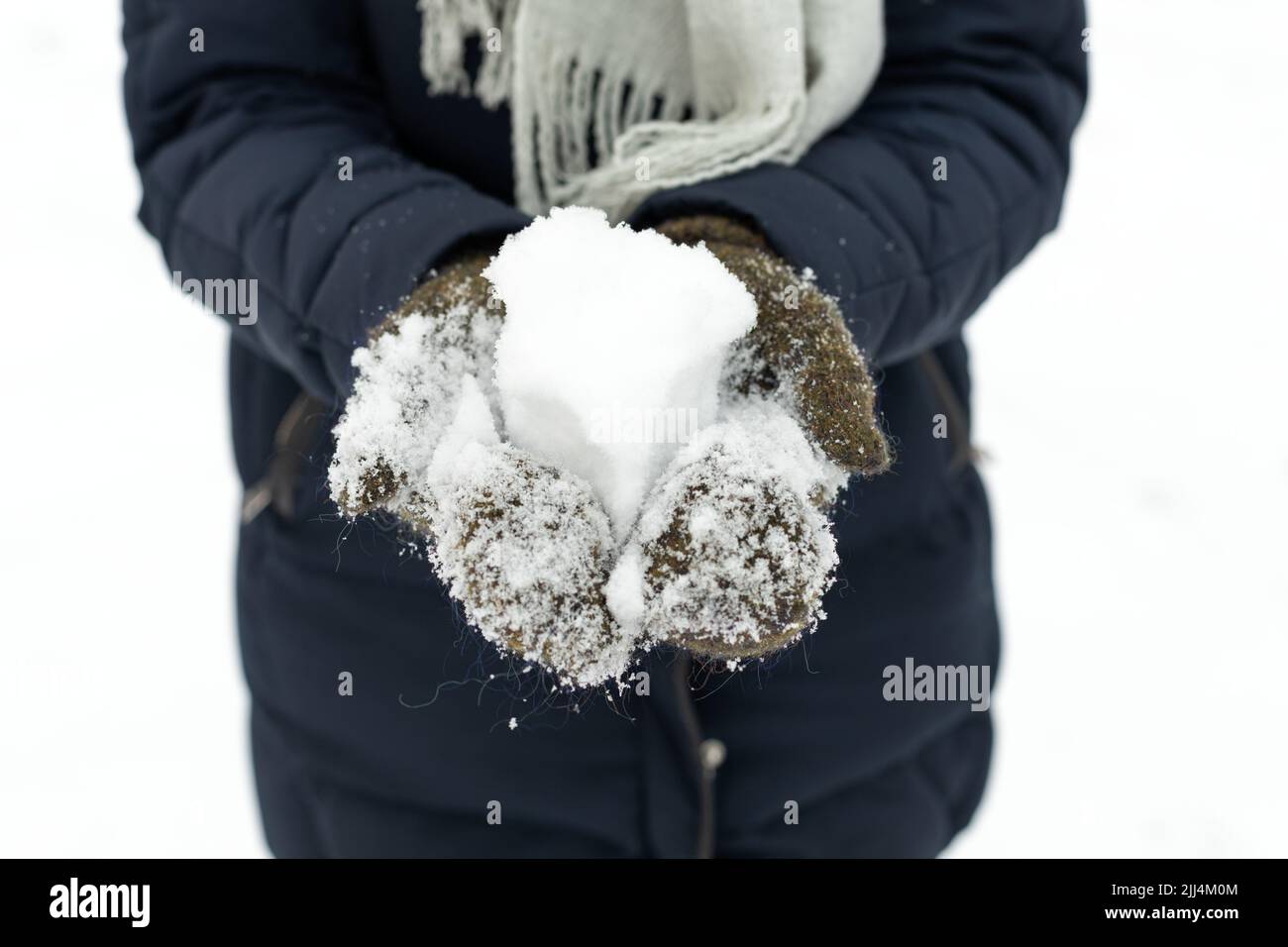 Picture of a woman's hand making round snowballs Stock Photo - Alamy