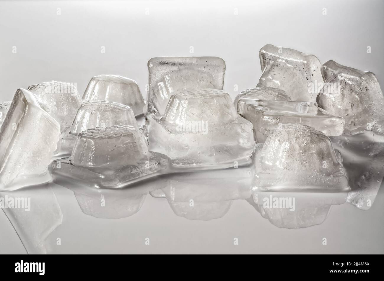 natural ice cubes on a light background, dissolving cubes of a dripping ...