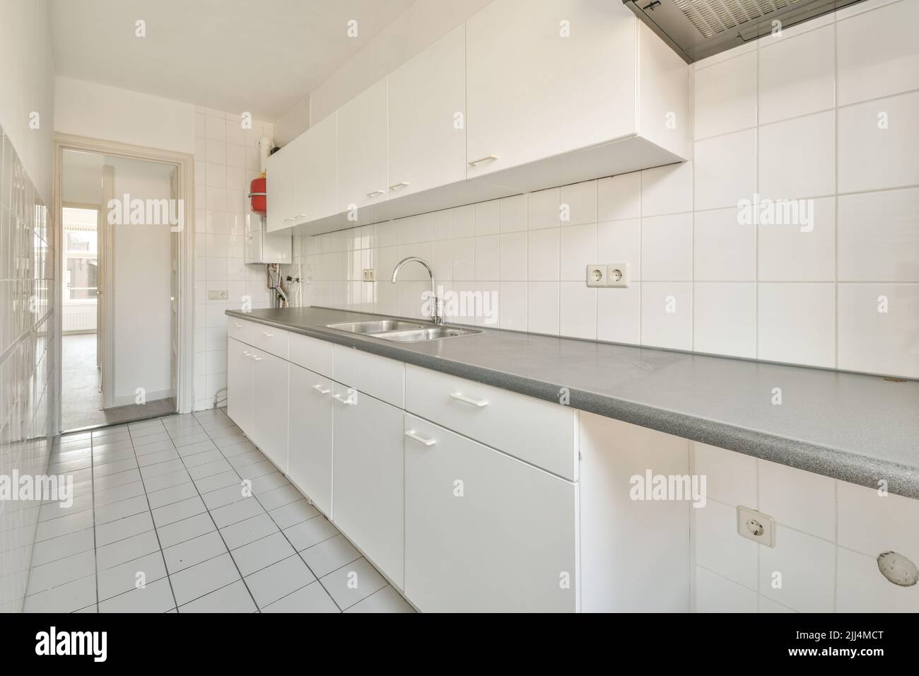 Interior of empty white kitchen with windows and wooden parquet floor ...
