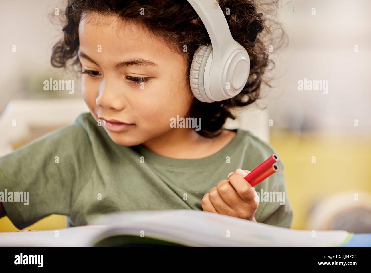 Focused on drawing the perfect picture. a little boy drawing while ...