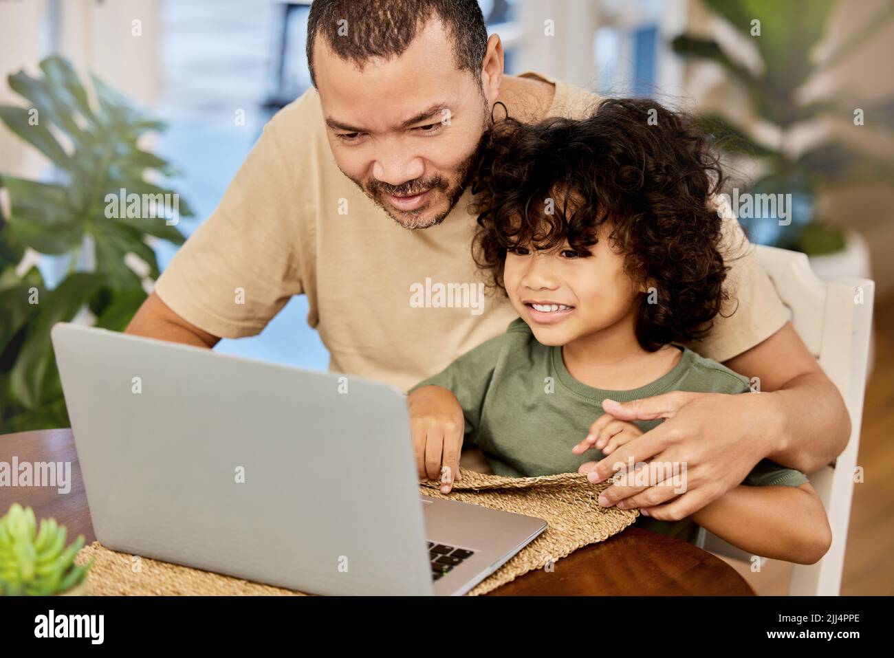 Technology has sparked his curiosity. a little boy and his father using ...