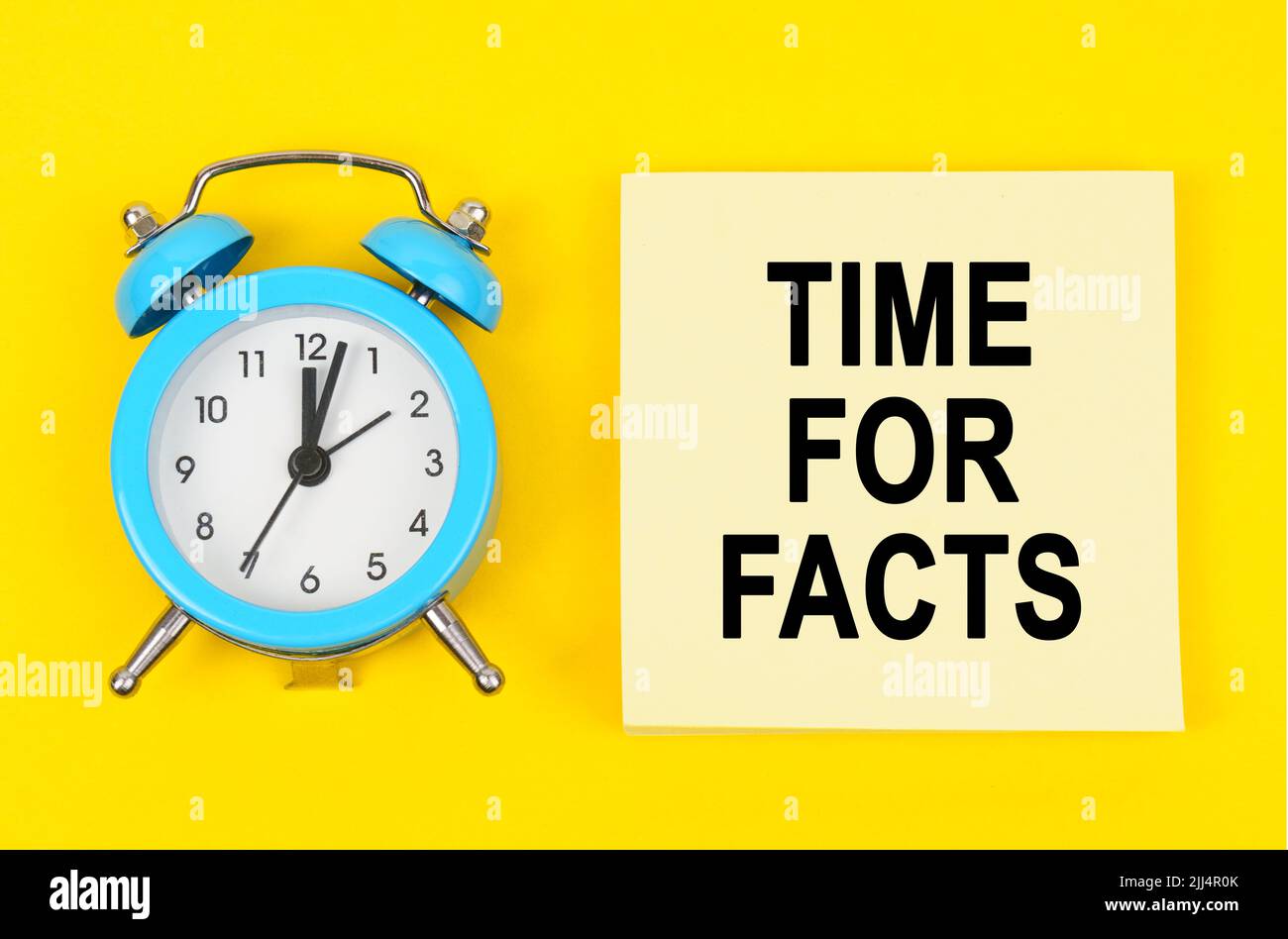 Business and finance concept. On a yellow background lie a clock and a ...