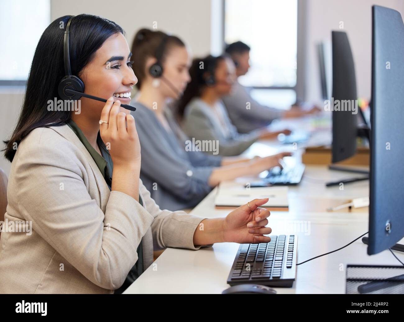 We take care of our customers. a young call centre agent working in an ...