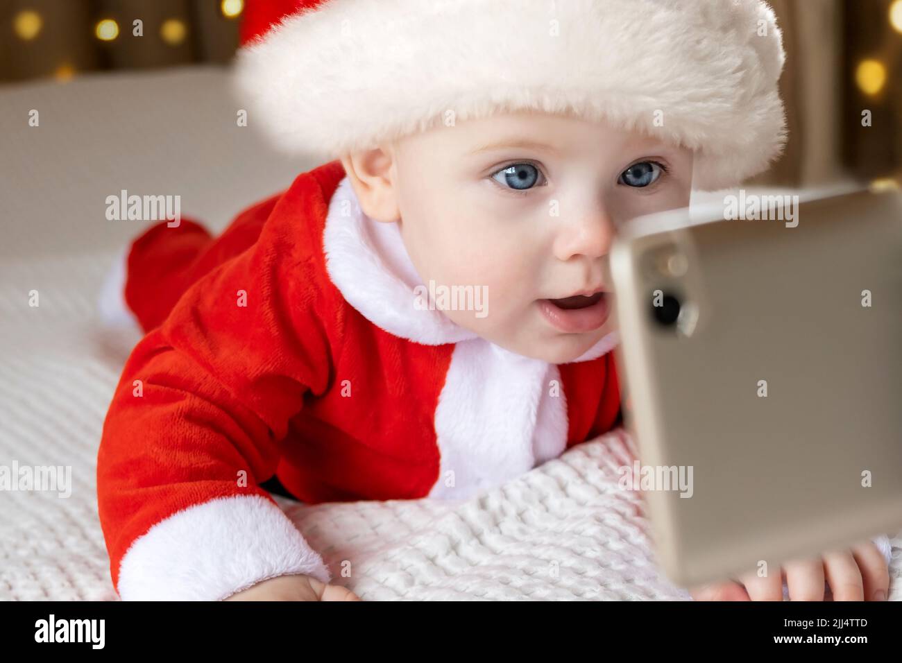 Beautiful little child is celebrating Christmas. New Year's holidays. A ...