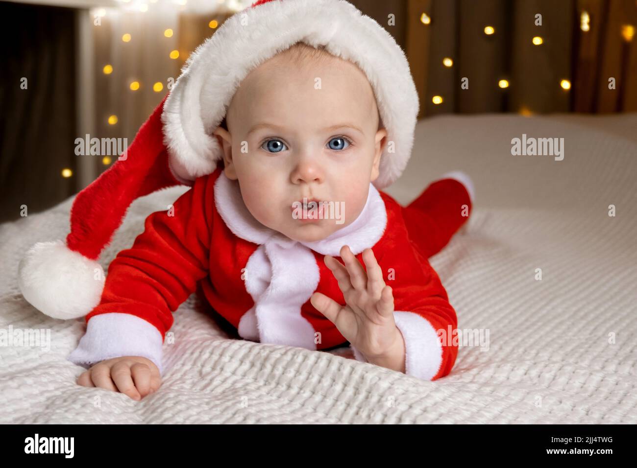 Beautiful little child is celebrating Christmas. New Year's holidays. A ...