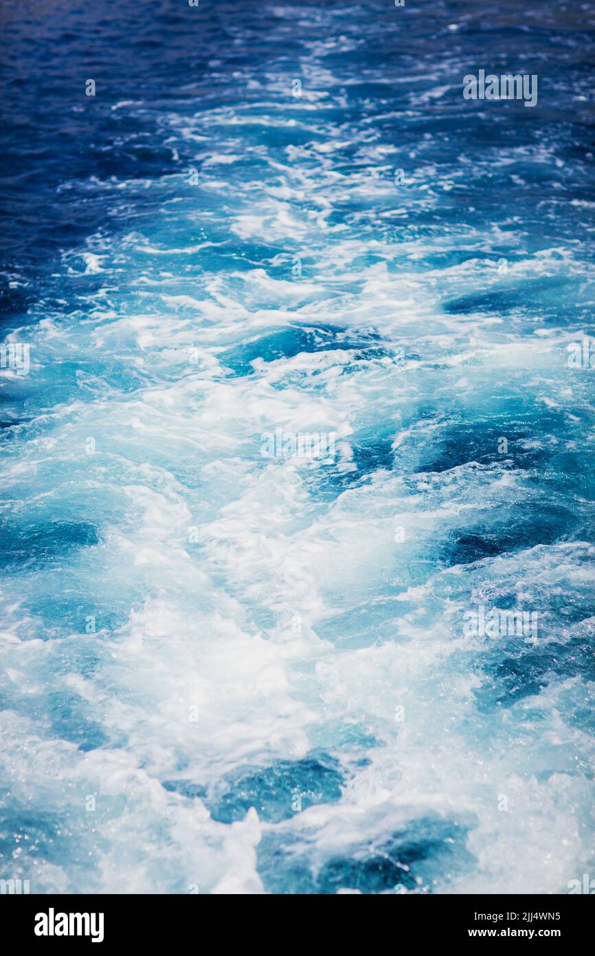 Wave trace tails of speed boat on a blue water surface in the sea Stock ...
