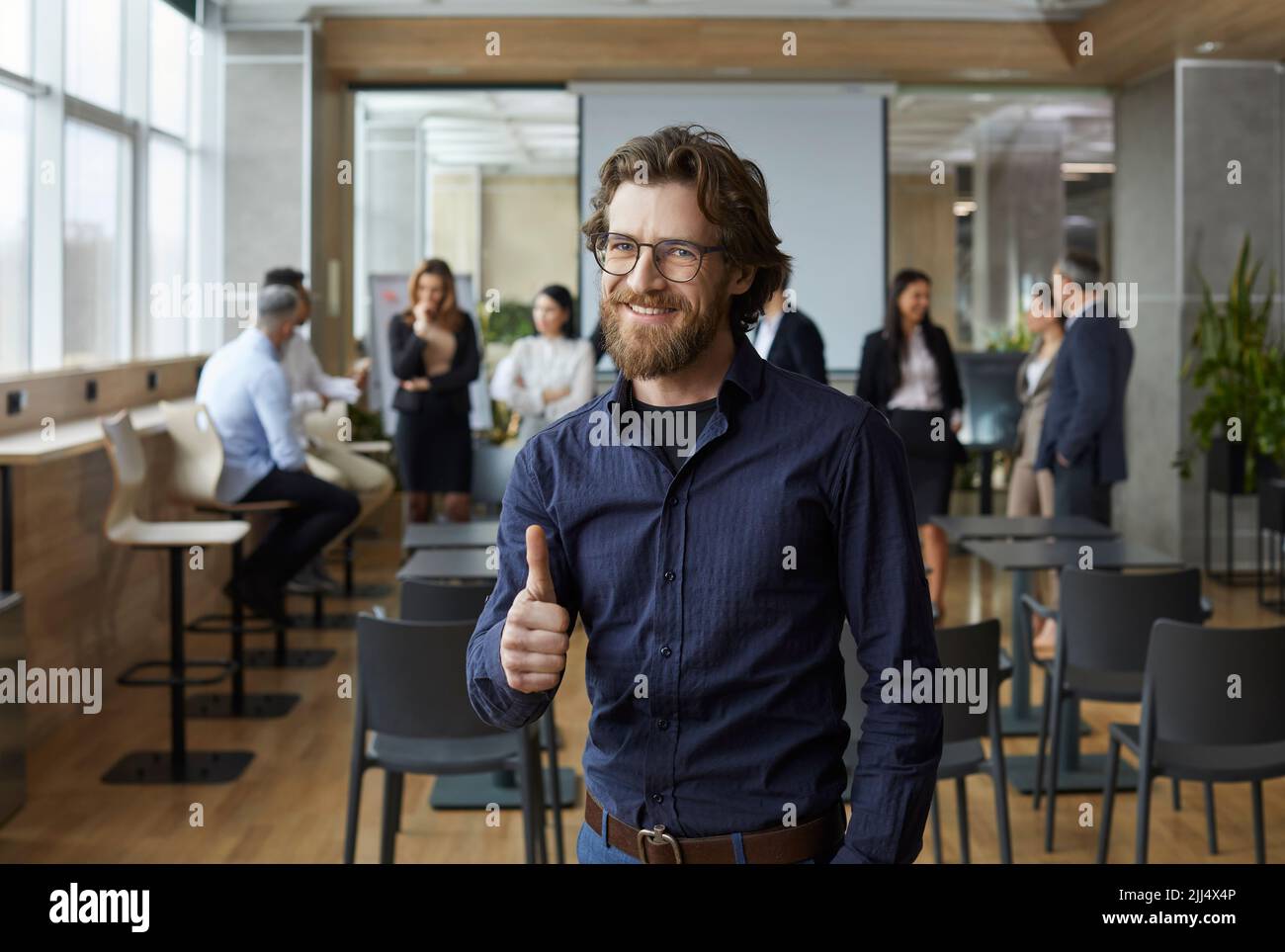 Happy man gives thumbs up and smiles as he shares feedback after ...