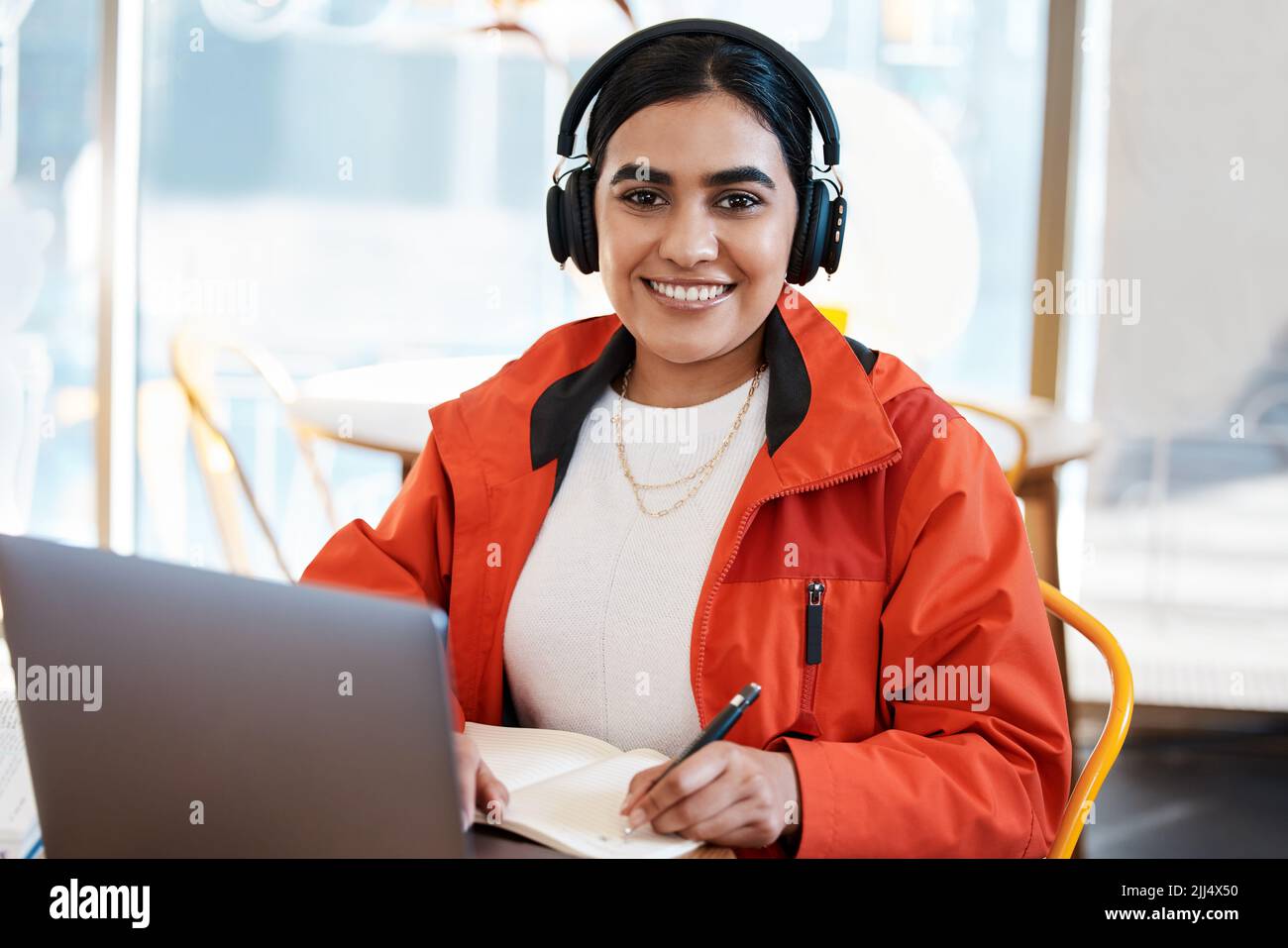 Im always studying. a young female student using a laptop while ...