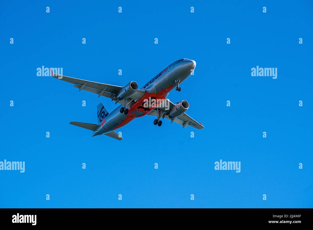 23 July 2022: The underside of a Jetstar commercial jet on approach to ...