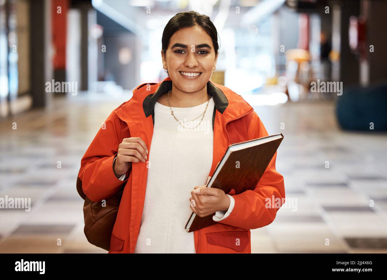 A whole new beginning. a young female student at college Stock Photo ...