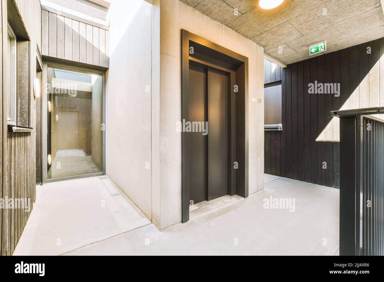 Shiny elevator with opened door located in illuminated hall of ...