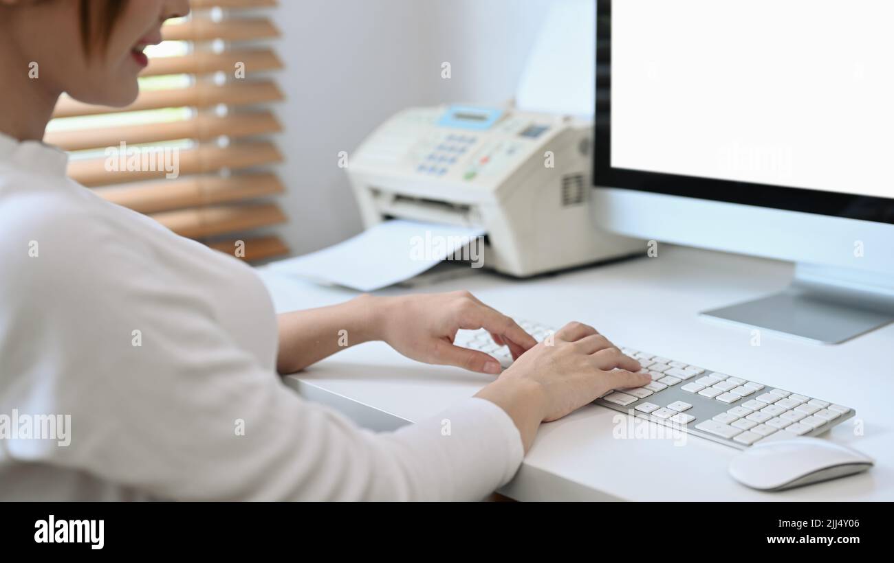 Over shoulder view of young female freelancer searching information ...