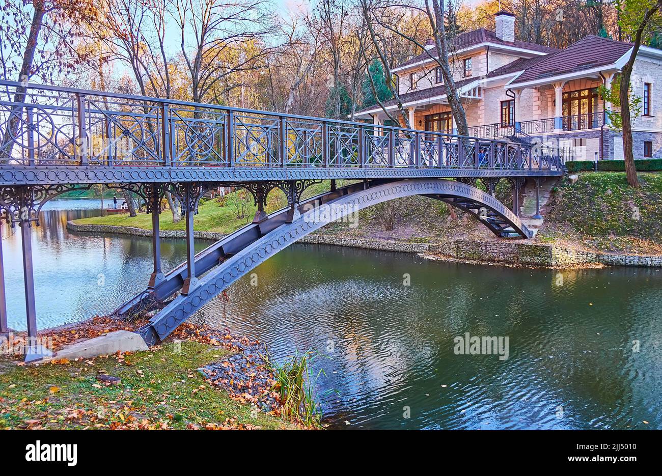 The metal footbridge with vintage style decors in a park with a small ...