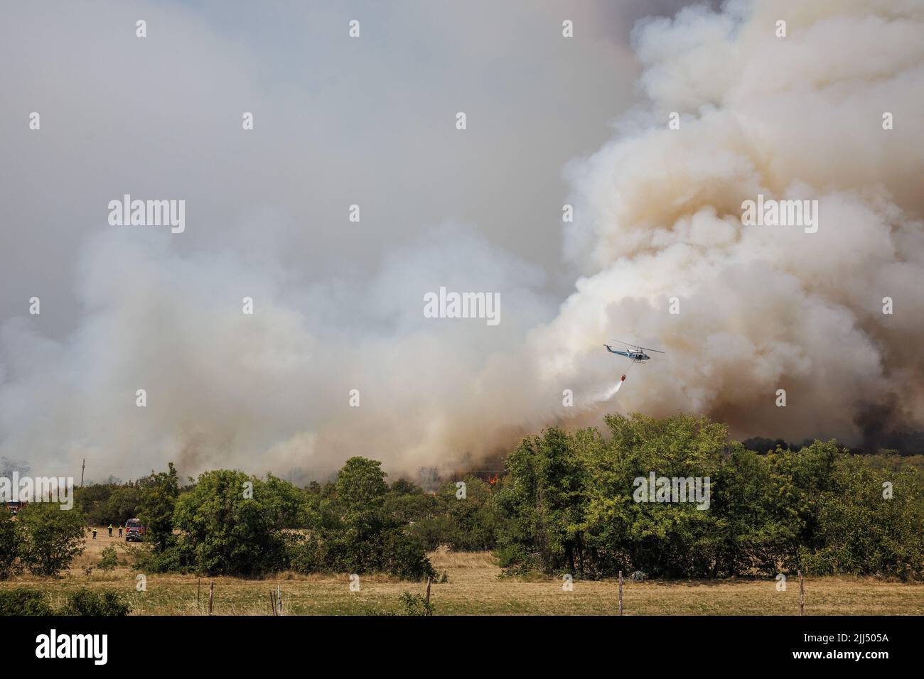 Firemen battle a large wildfire that burns near the village of Novelo ...