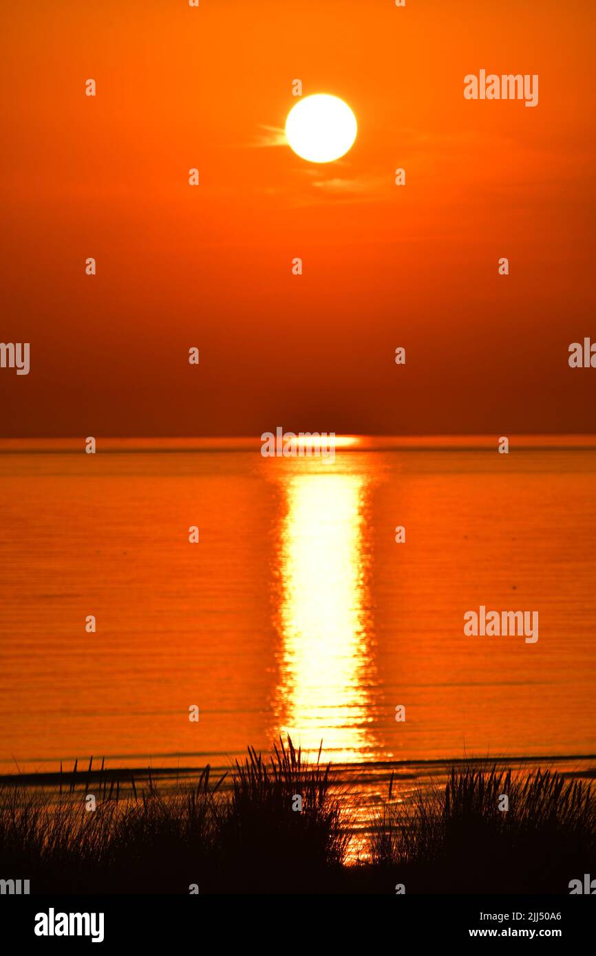 Deep orange sunset over the sea Stock Photo - Alamy