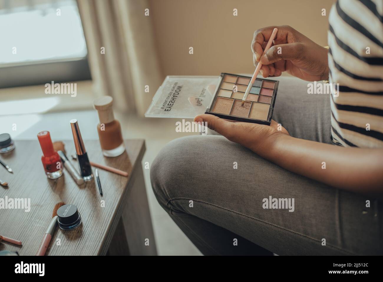 Young african american woman applying hi-res stock photography and images - Alamy