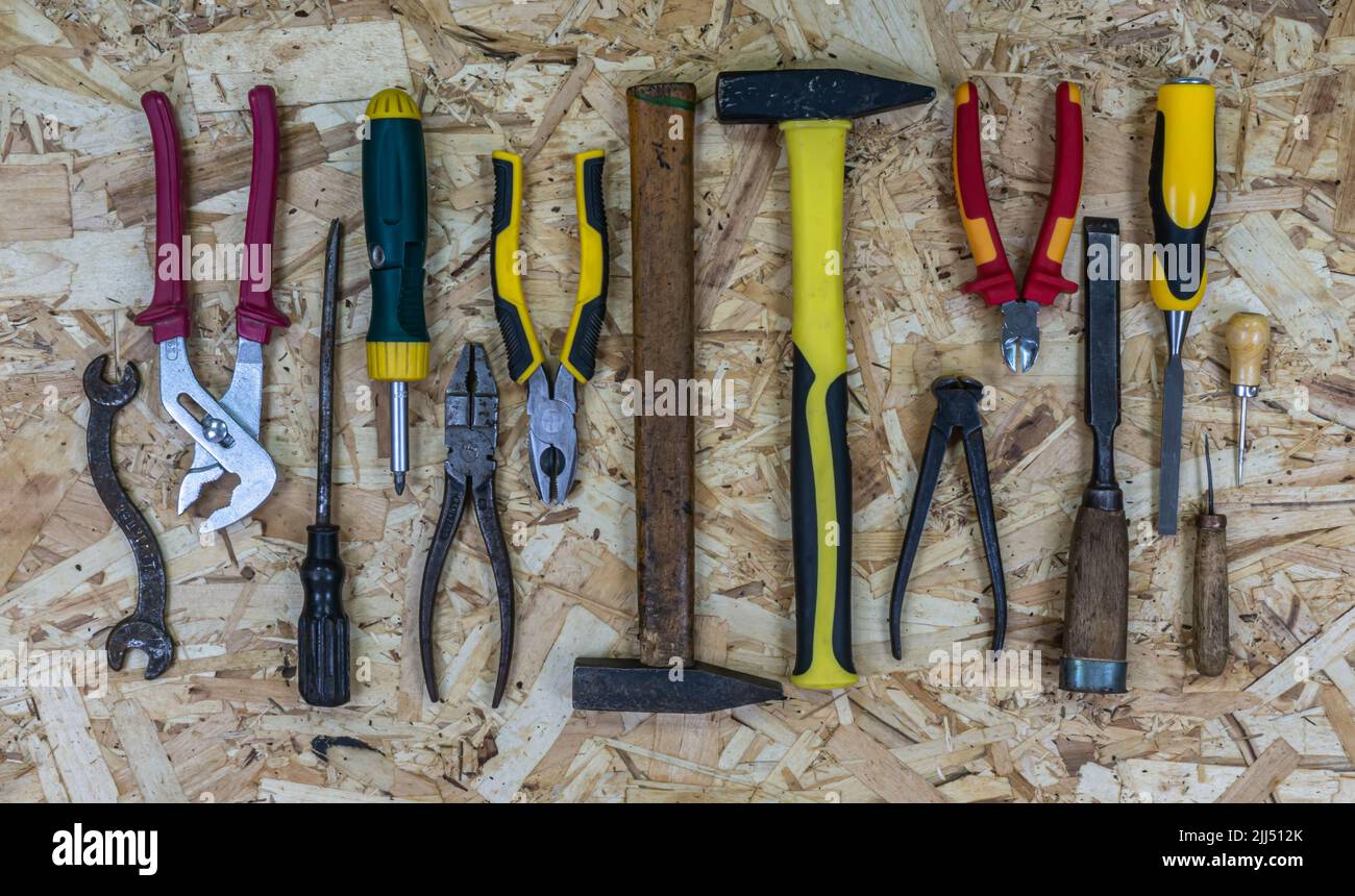 Old rusty tools versus modern tools on the OSB sheet. Concept ...