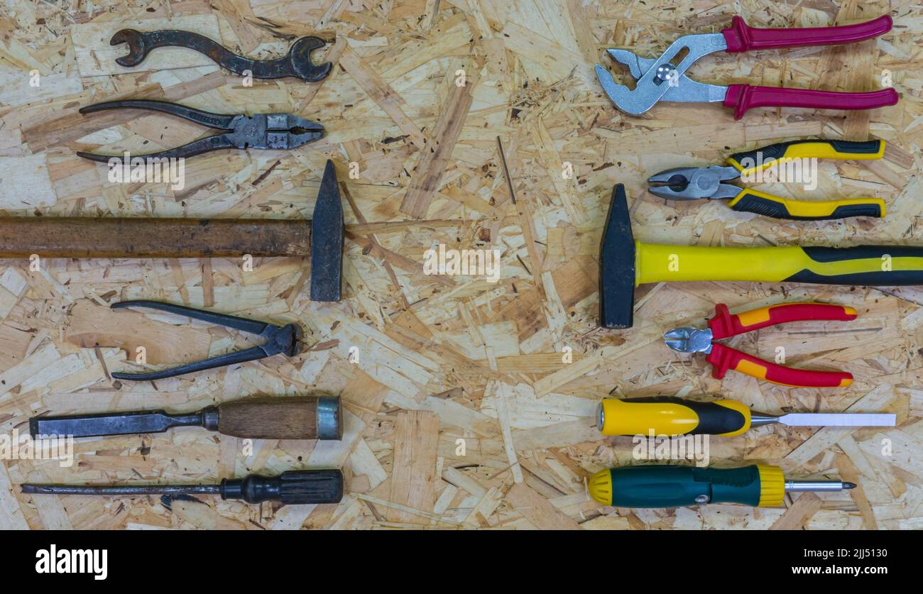 Old rusty tools versus modern tools on the OSB sheet. Concept ...
