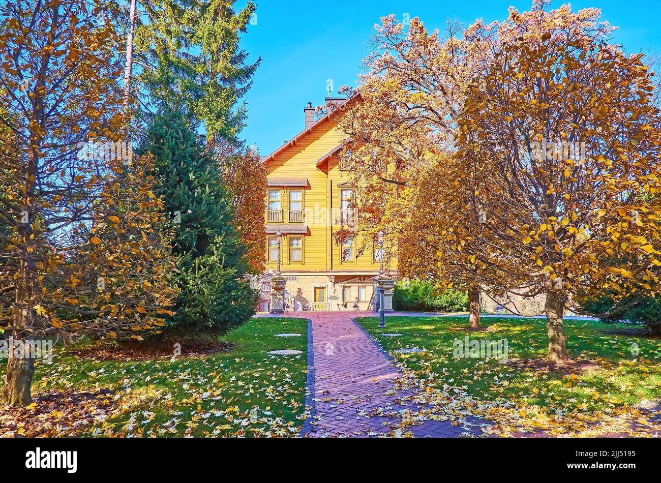Walk the narrow alley, covered with dry autumn foliage and surrounded ...