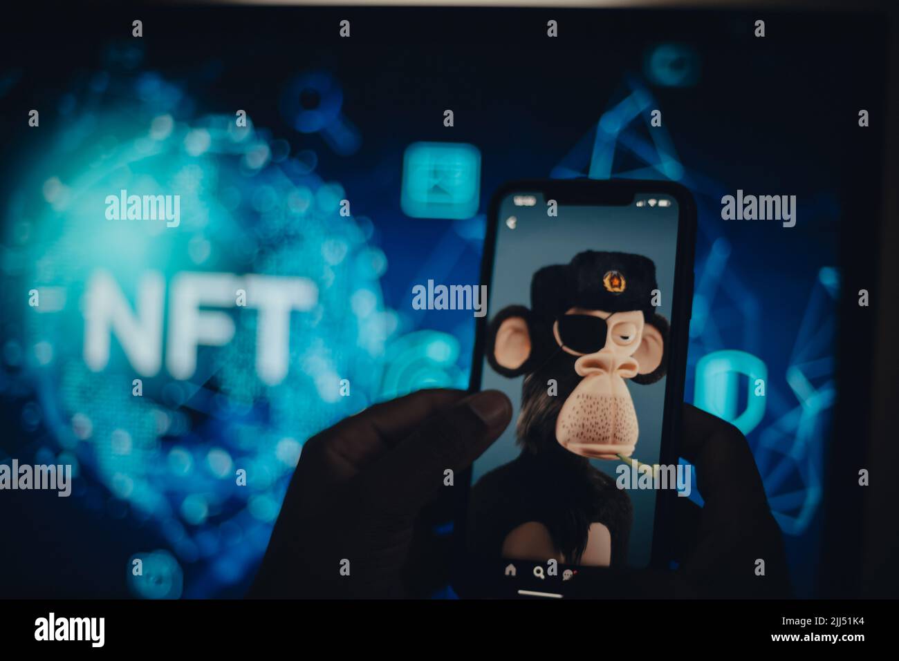 Hand holding a mobile phone showing an NFT Stock Photo - Alamy