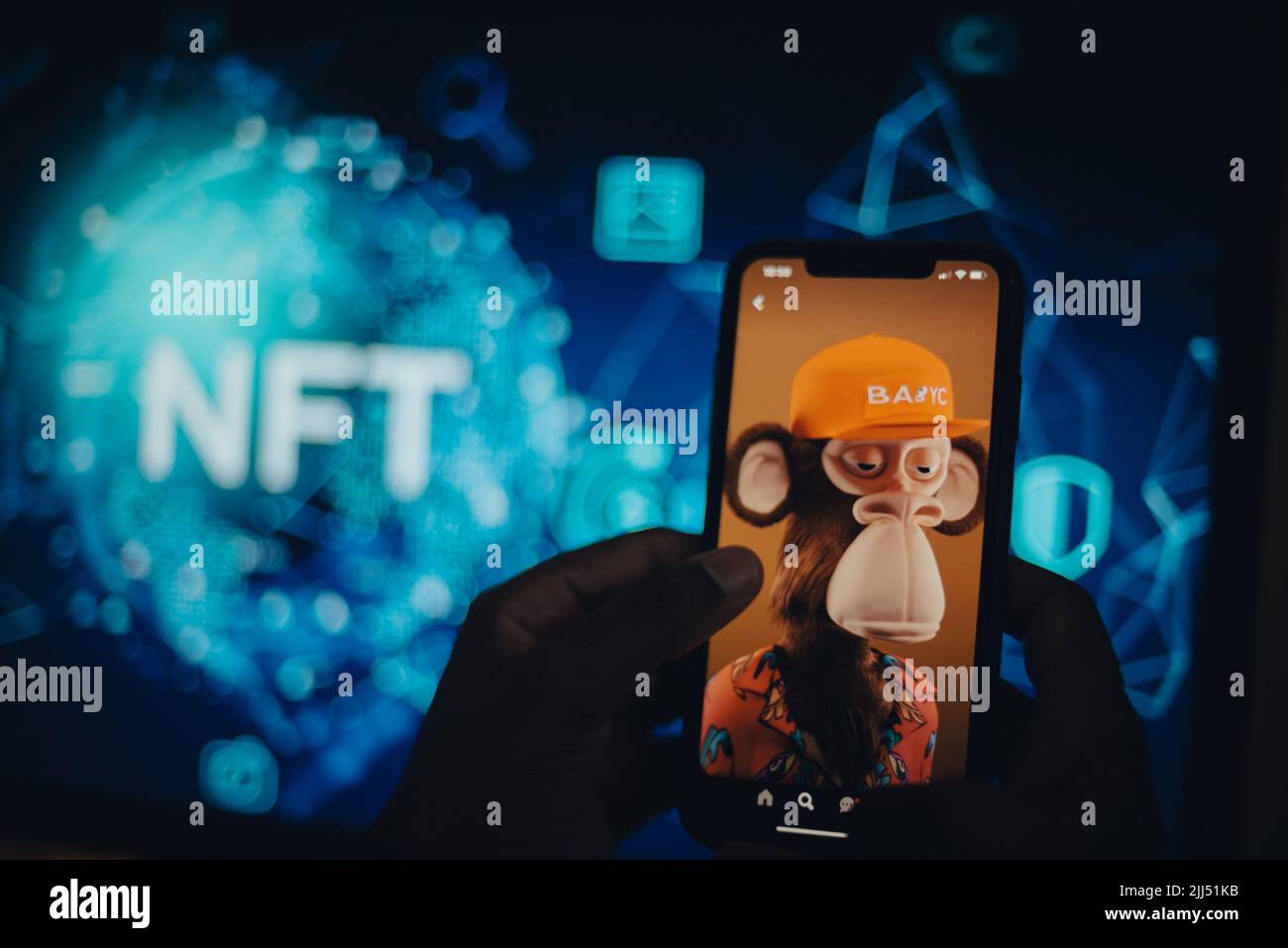 Hand holding a mobile phone showing an NFT Stock Photo - Alamy