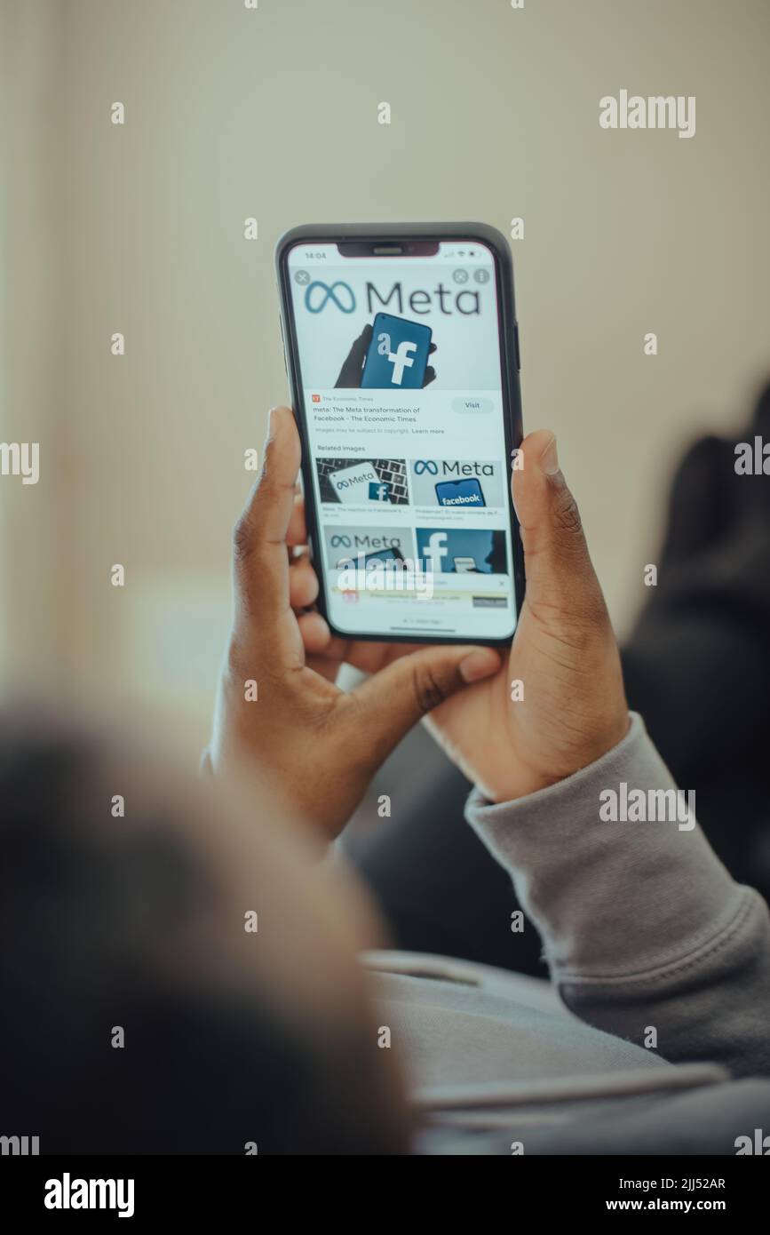 Close up of hands holding Meta facebook's new name on mobile phone with ...