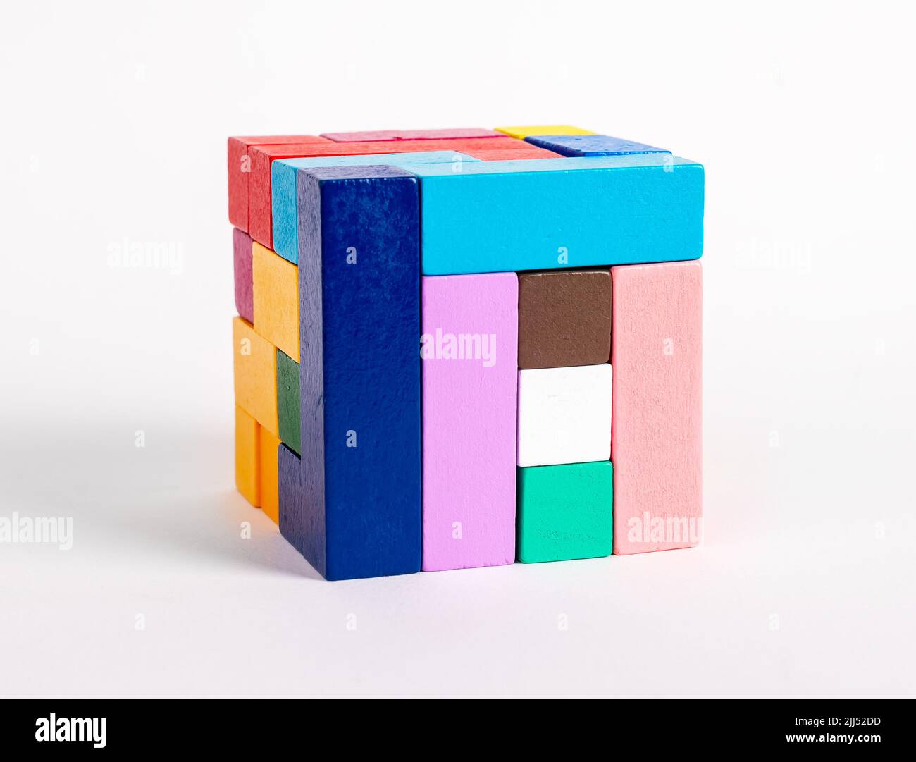 Wooden cube from multicolored blocks. Construction, successful work ...