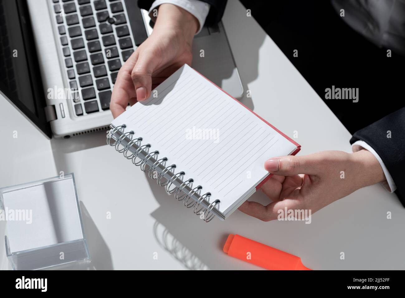 Businesswoman Holding Notebook Over Desk With Notes, Marker And Lap Top ...