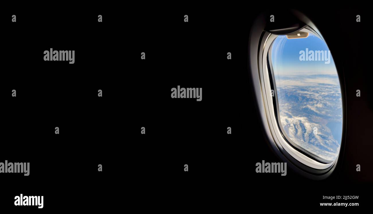 Beautiful scenery from the air through plane porthole. Bull's eye view ...