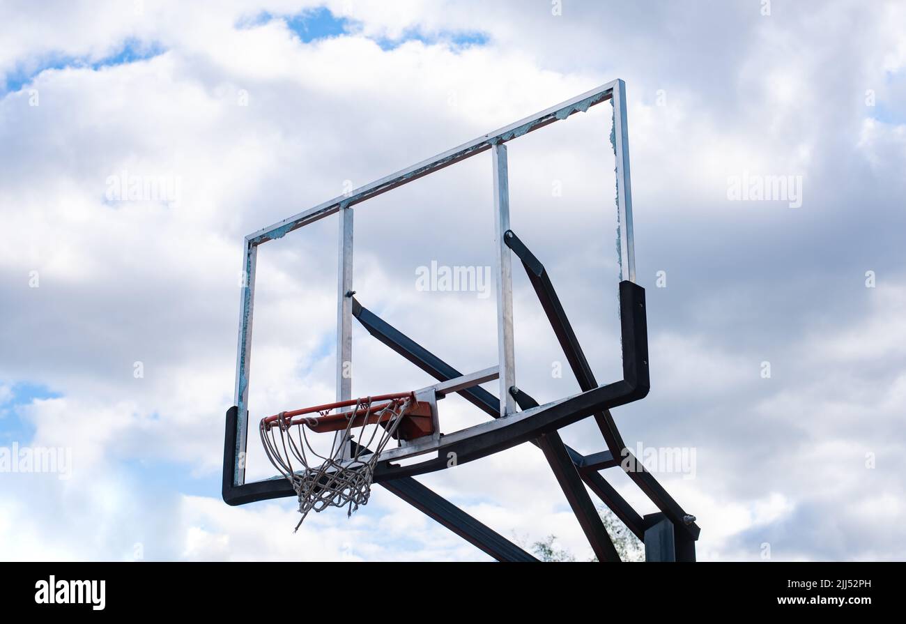 Broken glass backboard and broken hoop on the basketball court Stock ...
