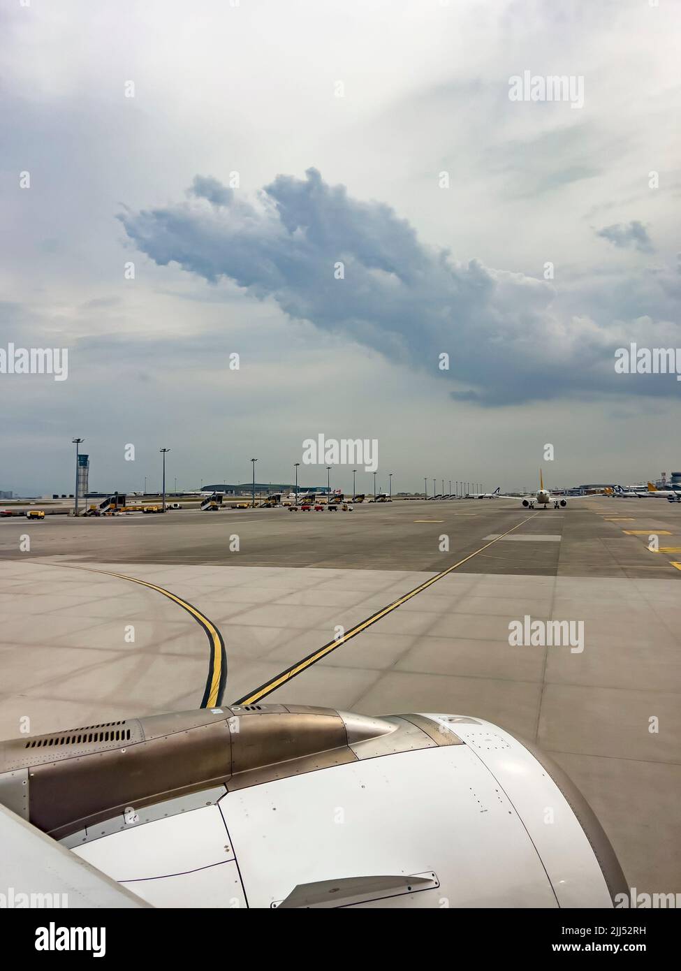 Airplane moving on airport tarmac towards takeoff airfield on cloudy ...