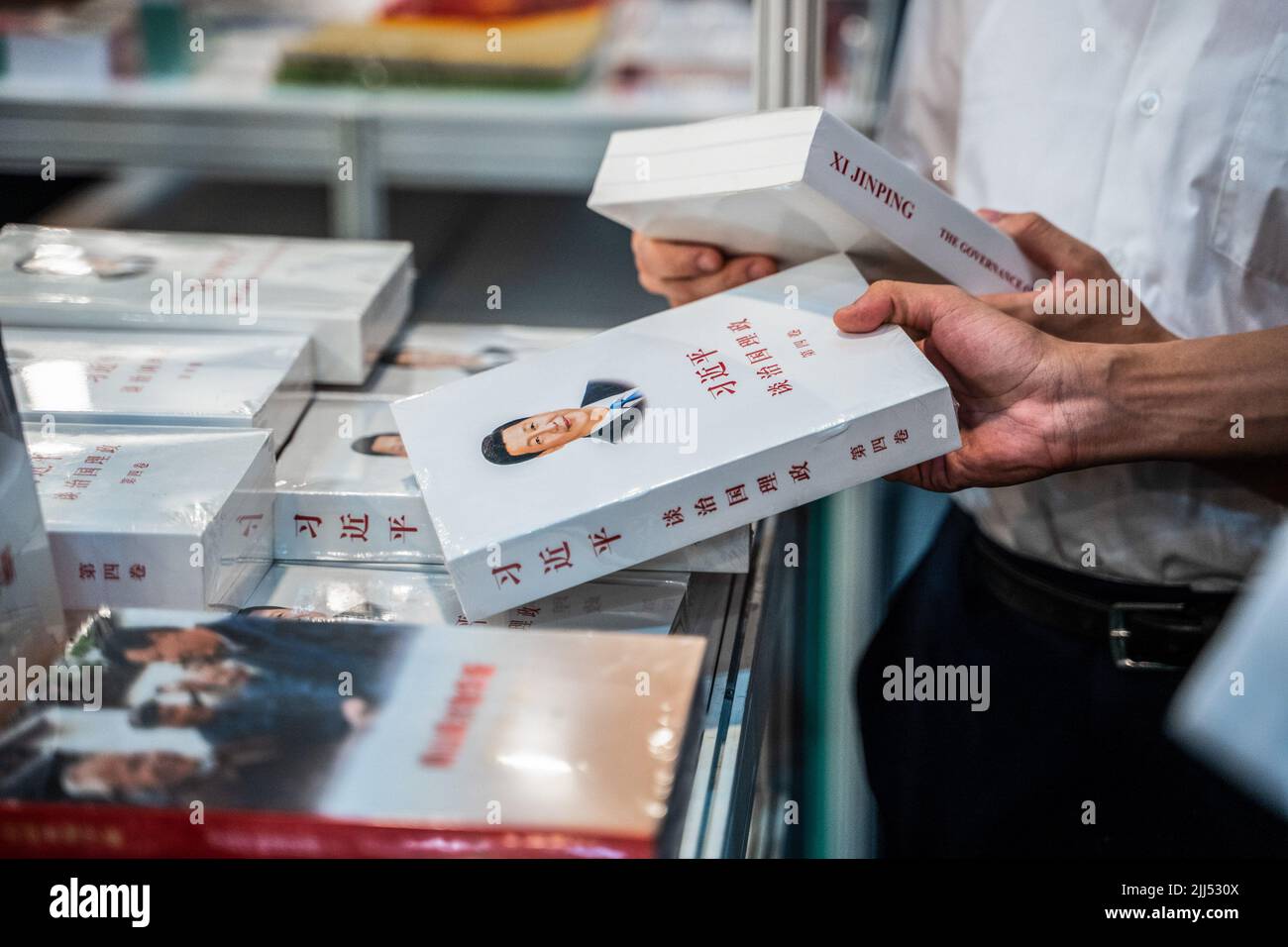 A person picks a book of Chinese President Xi Jinping's The Governance ...
