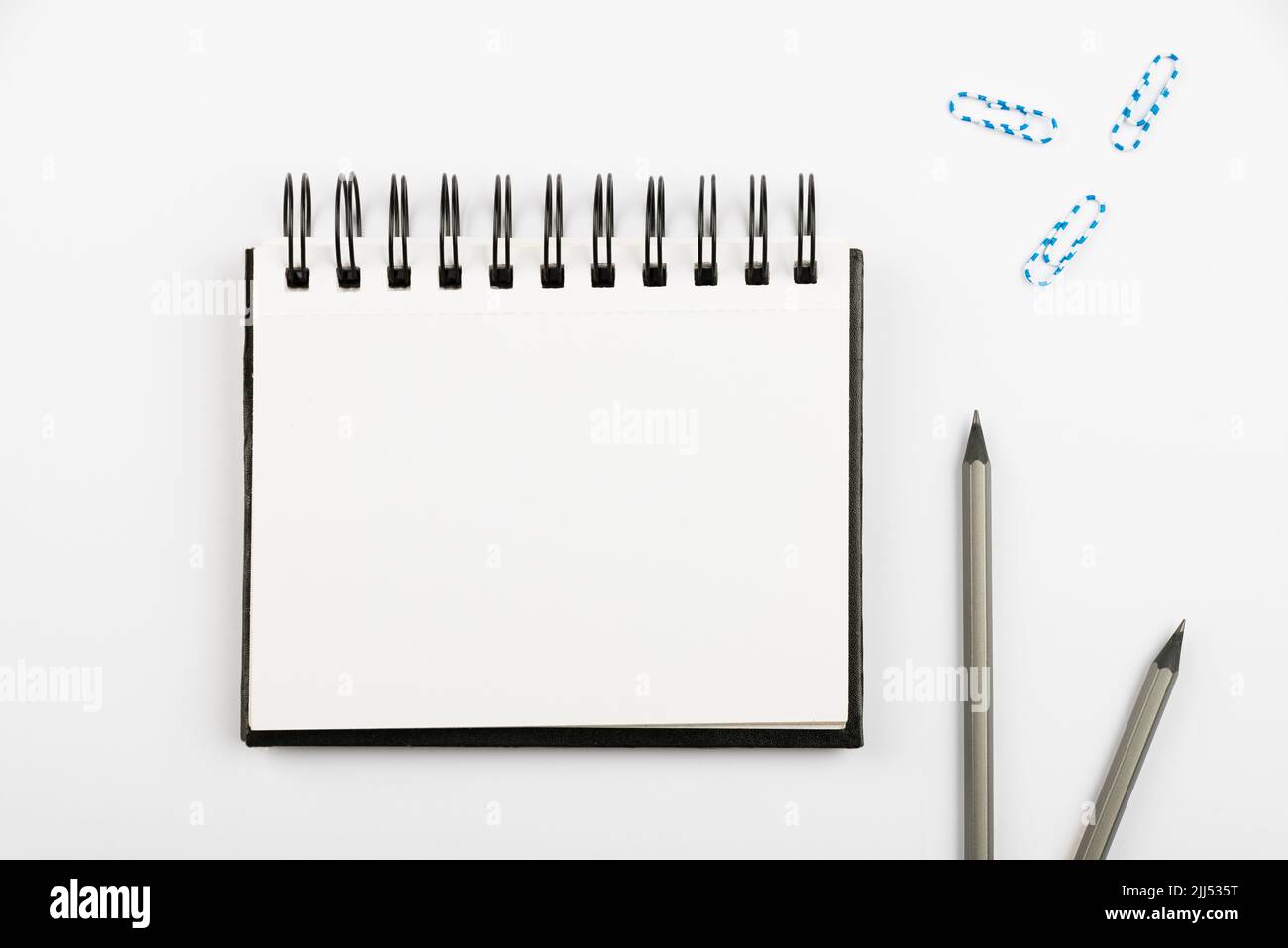 Notebook With Important Message On Desk With Pens And Paperclips ...