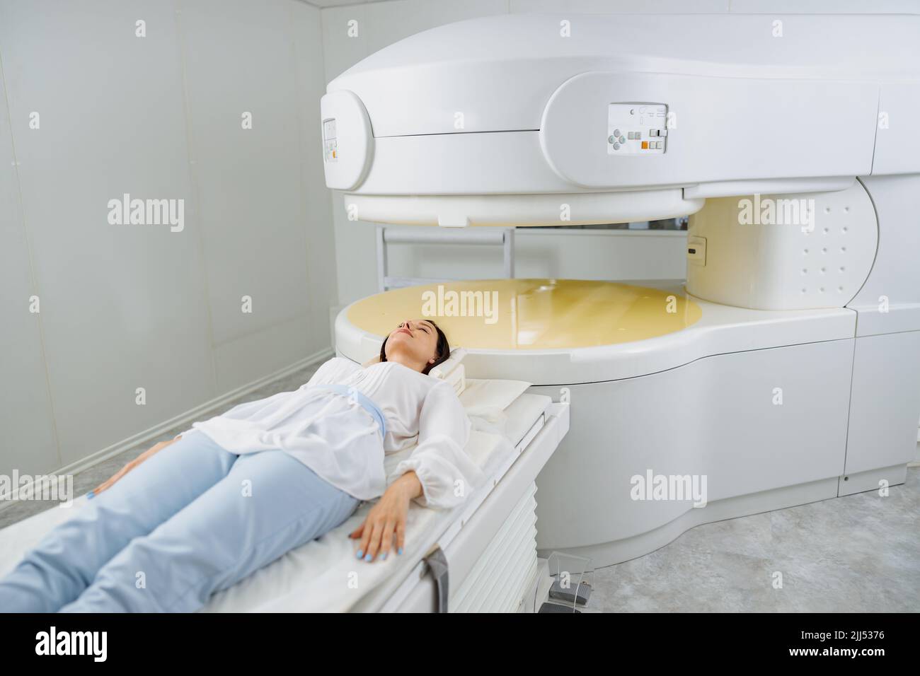Woman patient is ready to do magnetic resonance imaging MRI or CT scan ...