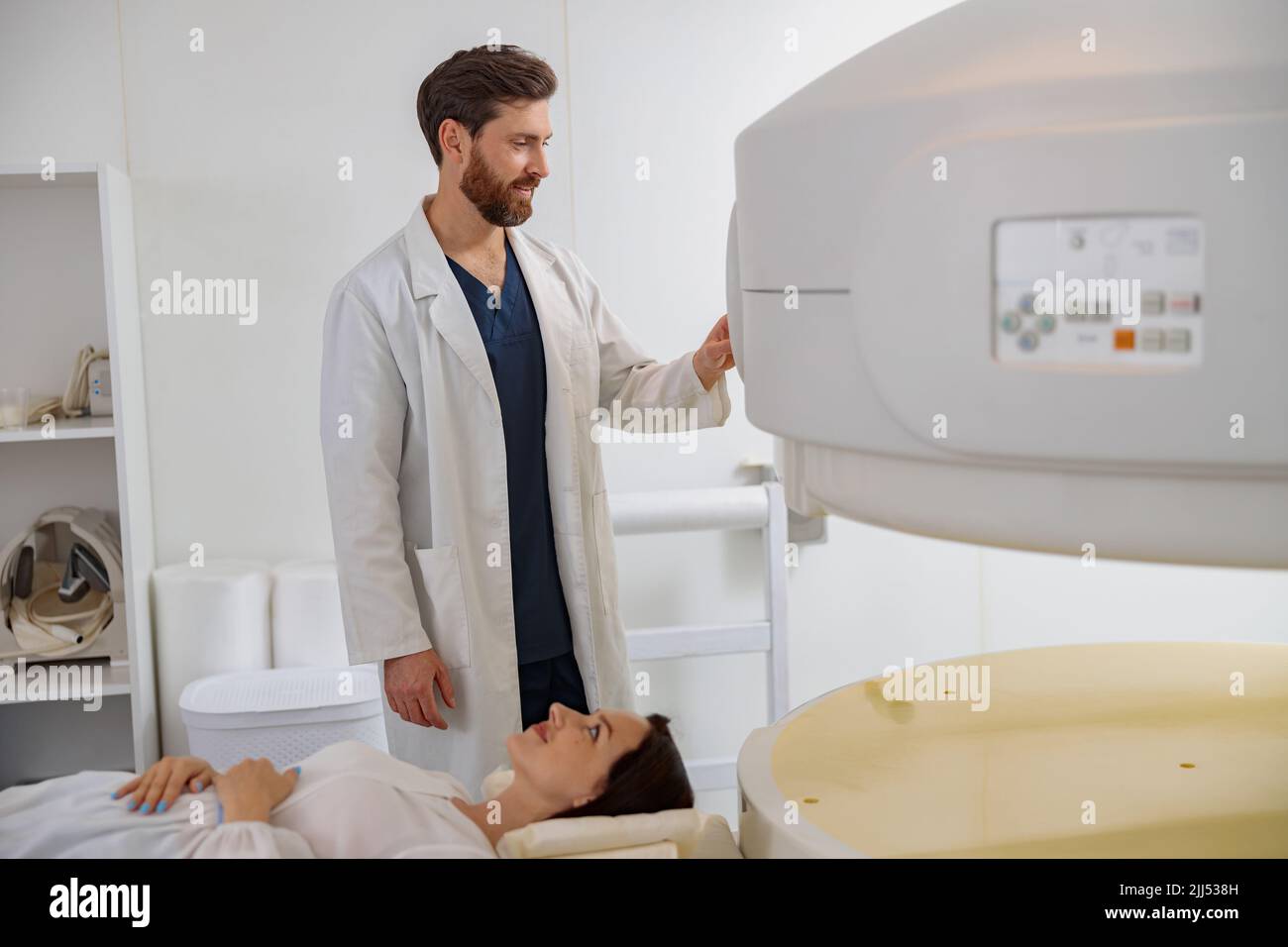 Radiologist controls MRI or CT or PET Scan with female patient ...