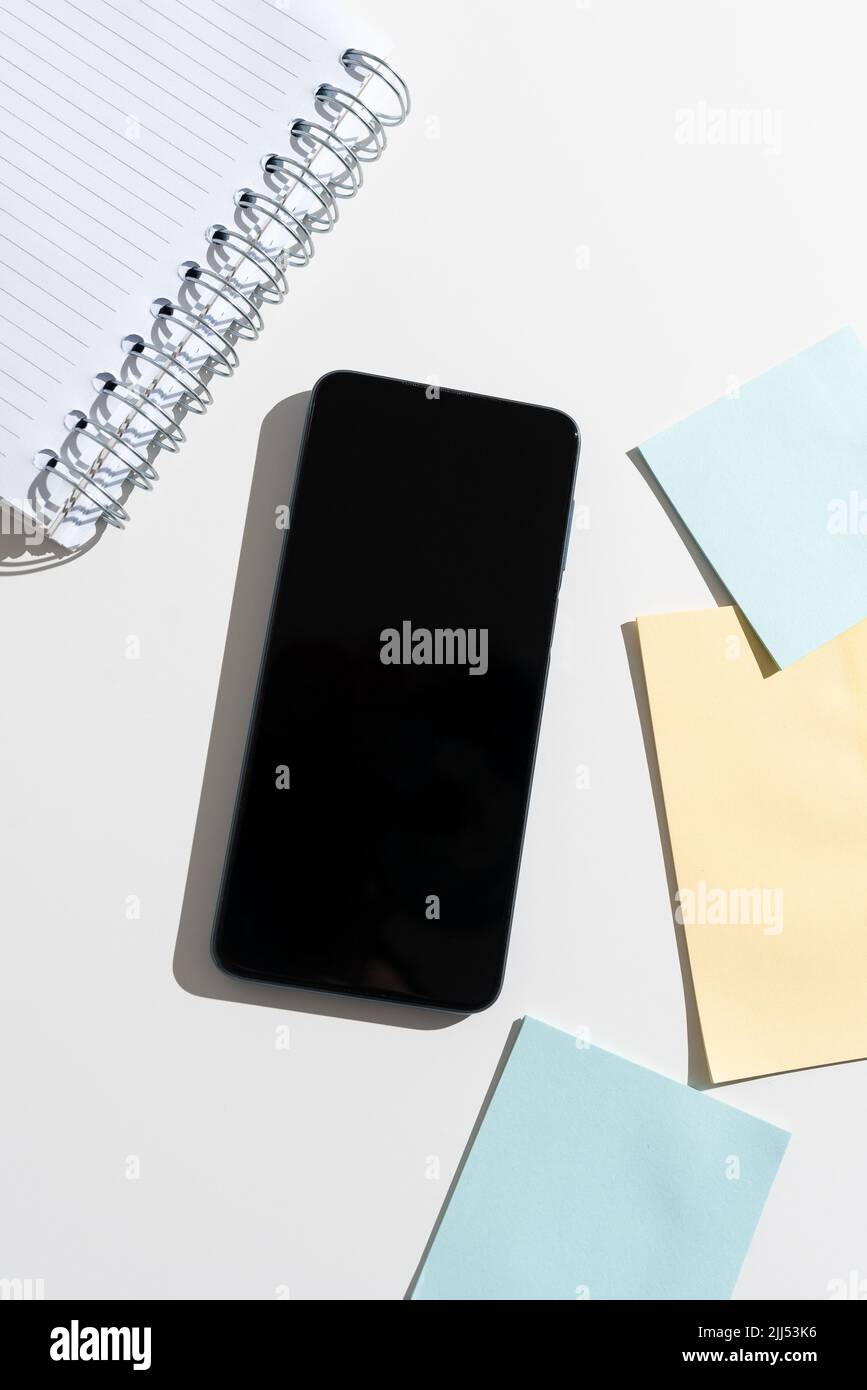 Mobile Phone With Important Message On Desk With Empty Notebook And ...