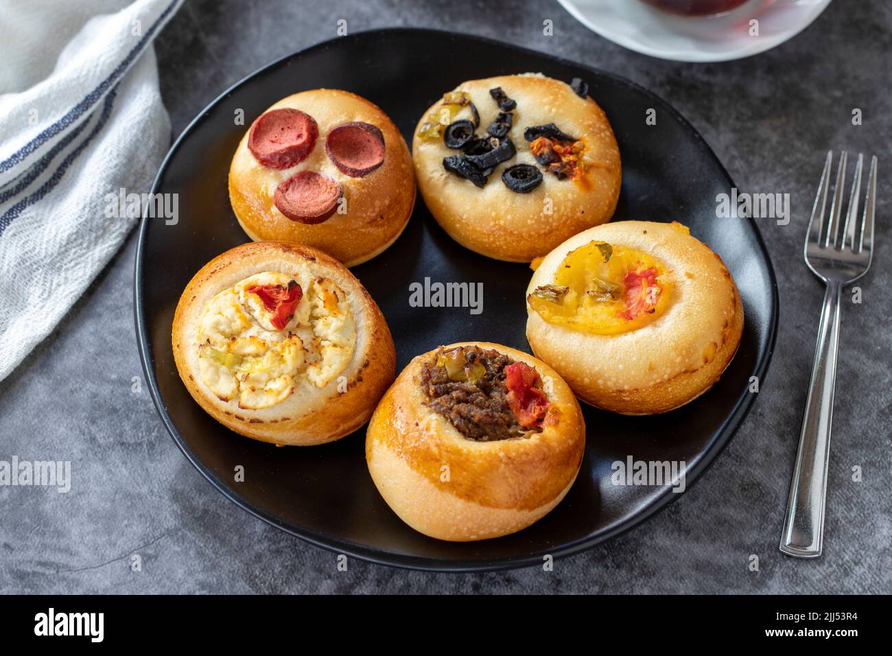 Small assortment of pizzas. Snack pizza on dark background. Bakery ...
