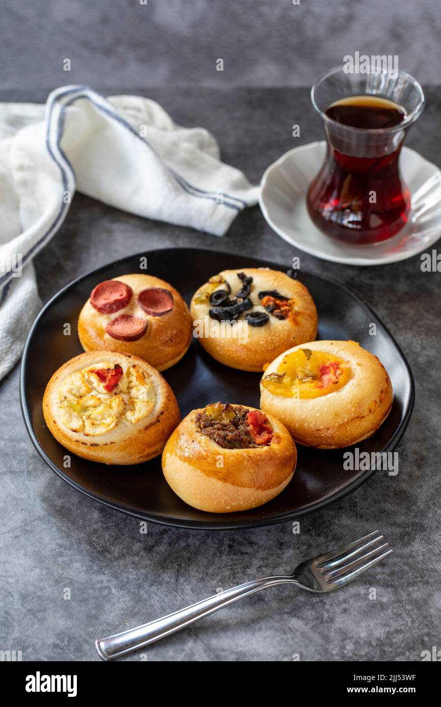 Small assortment of pizzas. Snack pizza on dark background. Bakery ...