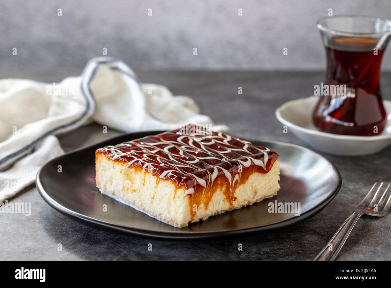 Trilece dessert. Slice of dessert with caramel and milk on a dark ...