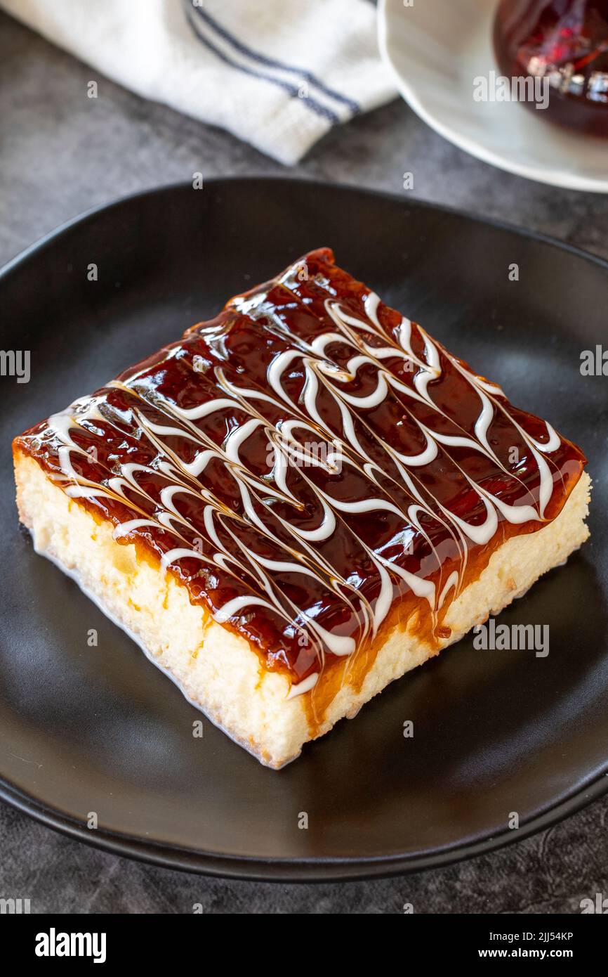 Trilece dessert. Slice of dessert with caramel and milk on a dark ...