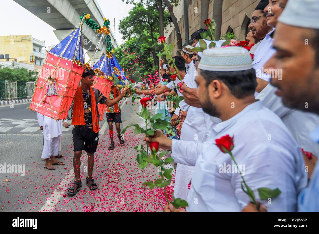 New Delhi, India. 22nd July, 2022. People belonging to Muslim community shower flower petals on ...