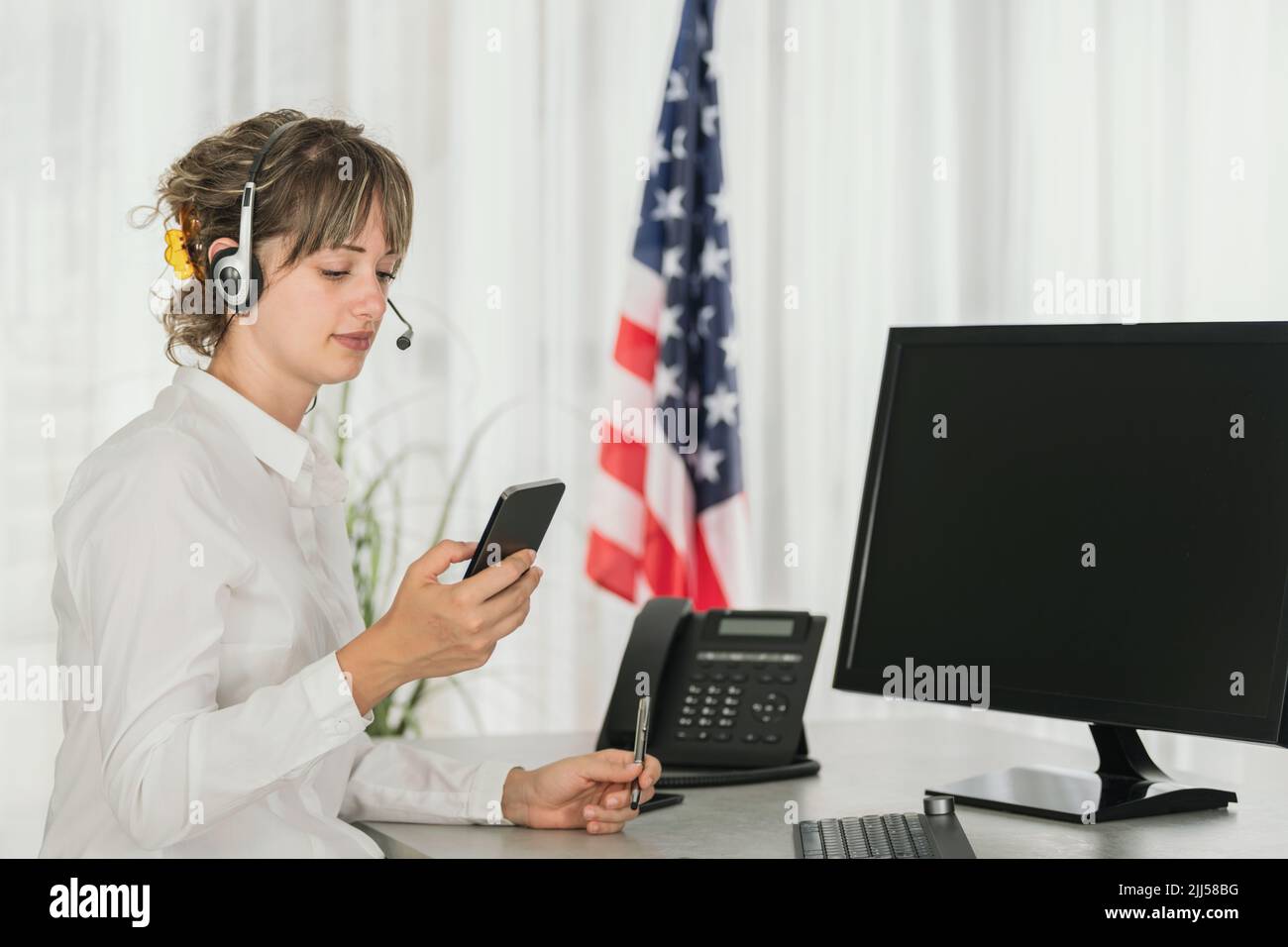 Side view woman customer support call operator in office using mobile ...