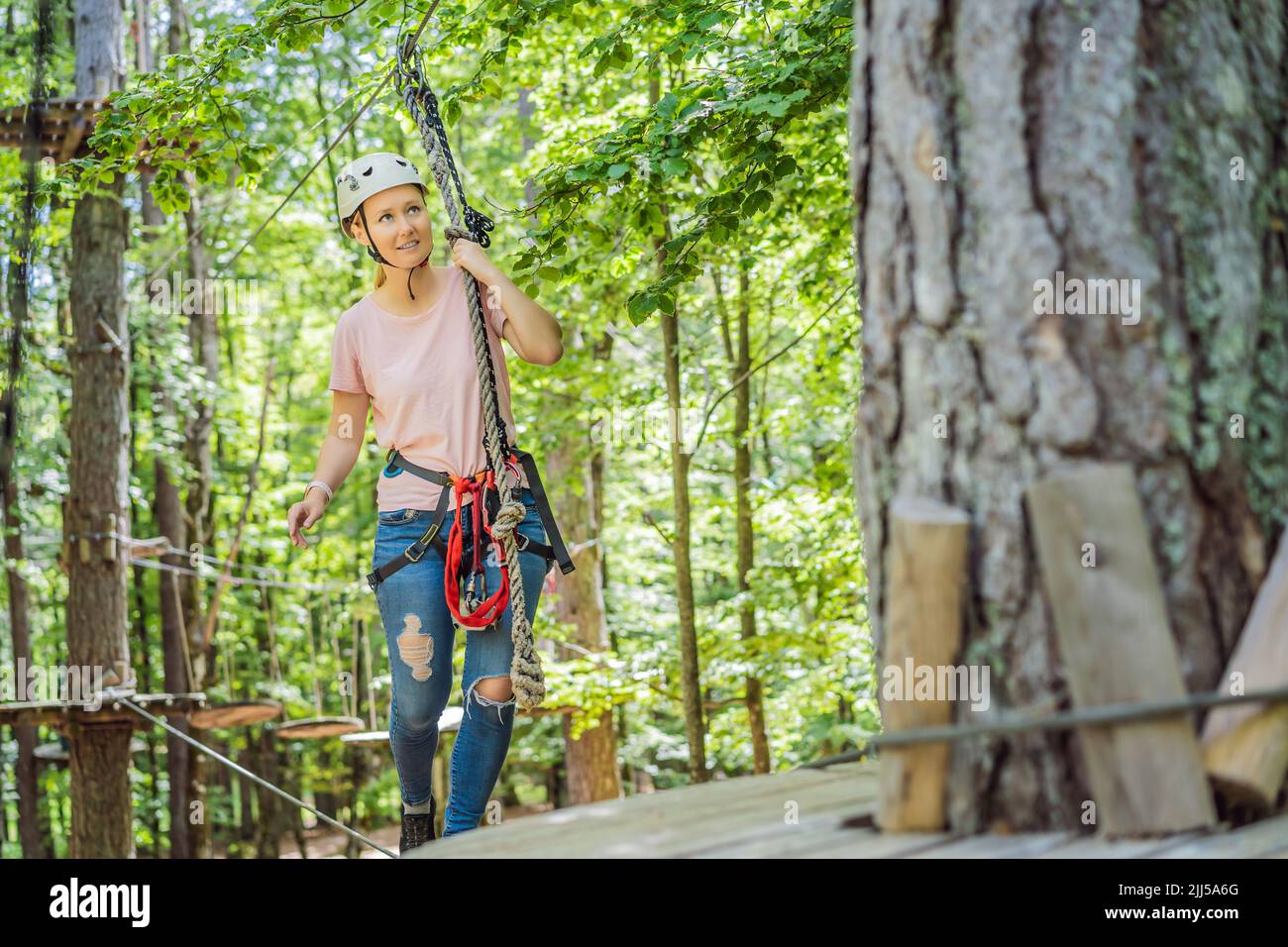 Happy women girl female gliding climbing in extreme road trolley ...