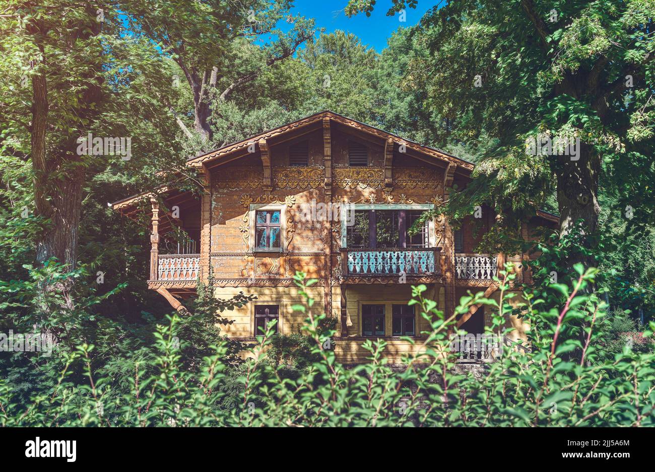 old german wooden house with ornaments in the middle of the forest ...