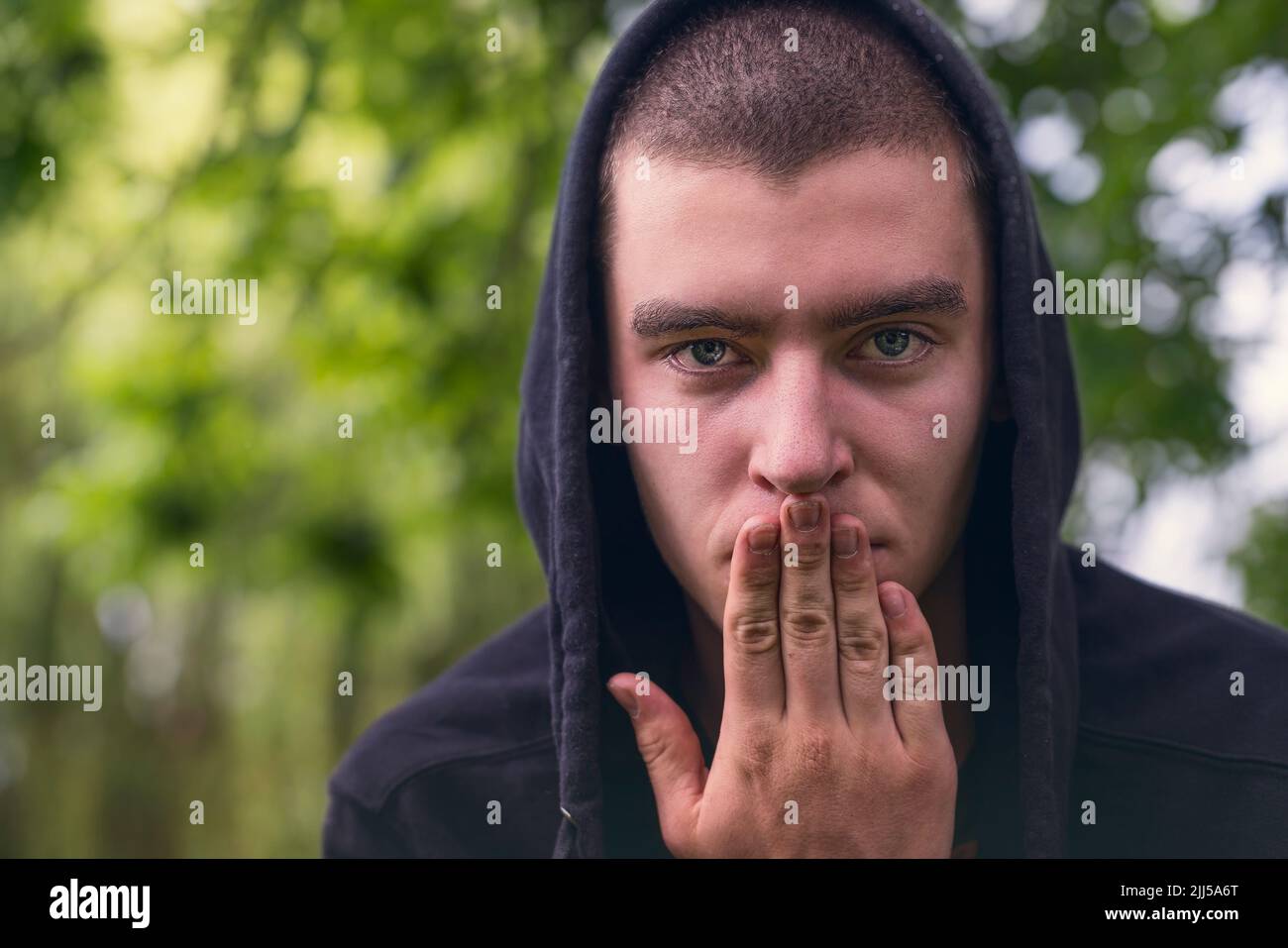 Man hand over mouth serious hi-res stock photography and images - Alamy