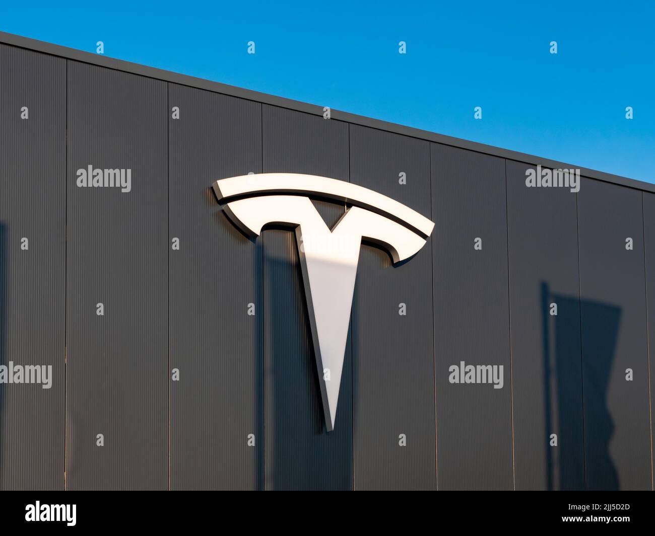 Tesla Inc. logo on the facade of a building exterior. Tesla service ... Tesla Inc. logo on the facade of a building exterior. Tesla service ...
